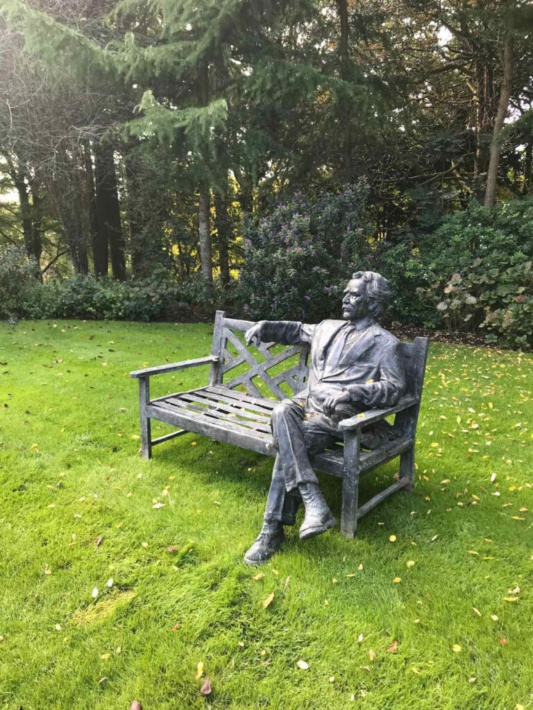 A unique bronze bench featuring a life size statue of a seated Albert ...